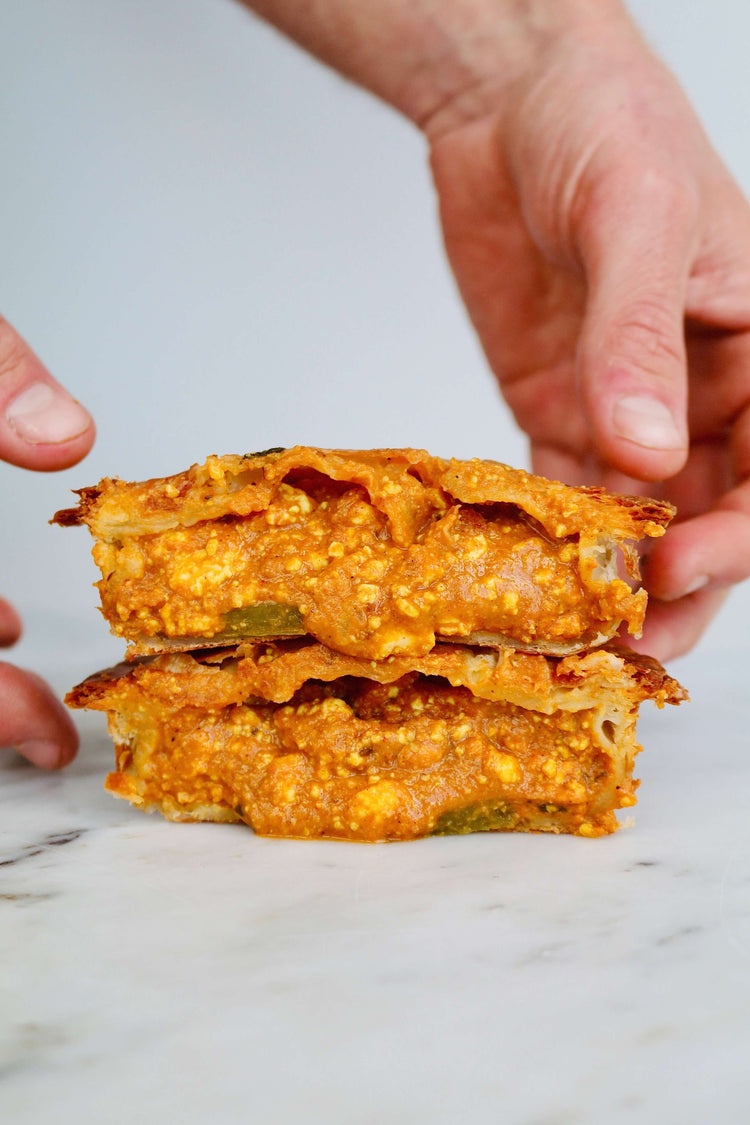 Roti Bros | Pies made with a flaky roti pastry.