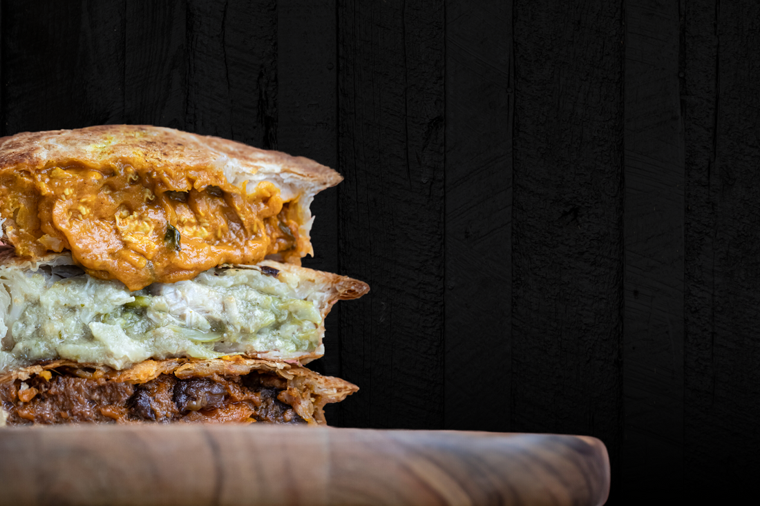 Roti Bros | Pies made with a flaky roti pastry.