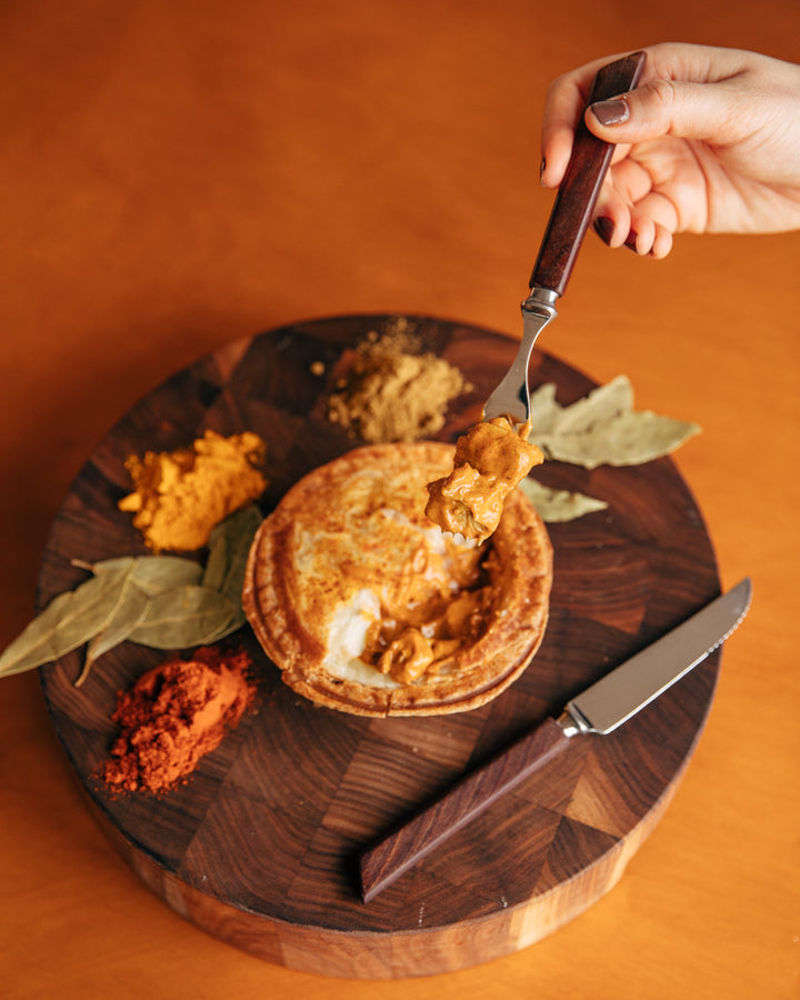 Roti Bros | Pies made with a flaky roti pastry.